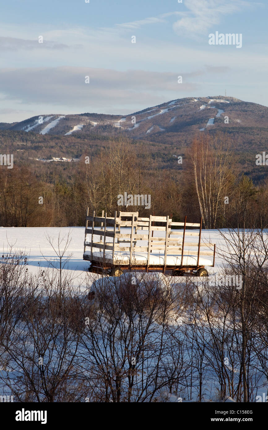 Wooden wagon in snowy field, ski slopes in winter, Mount Sunapee Ski ...