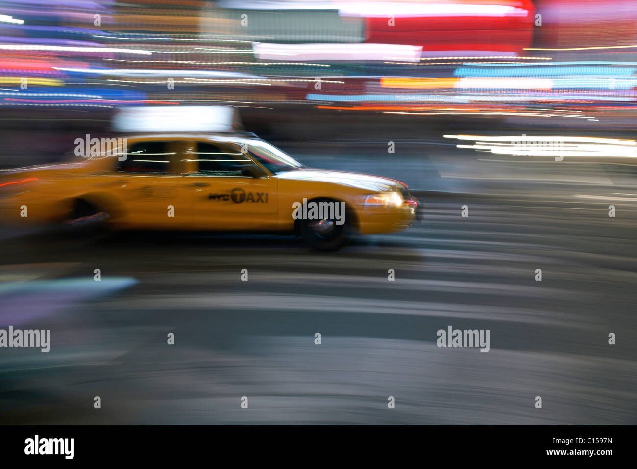 Speeding yellow taxi in Midtown Manhattan Stock Photo - Alamy