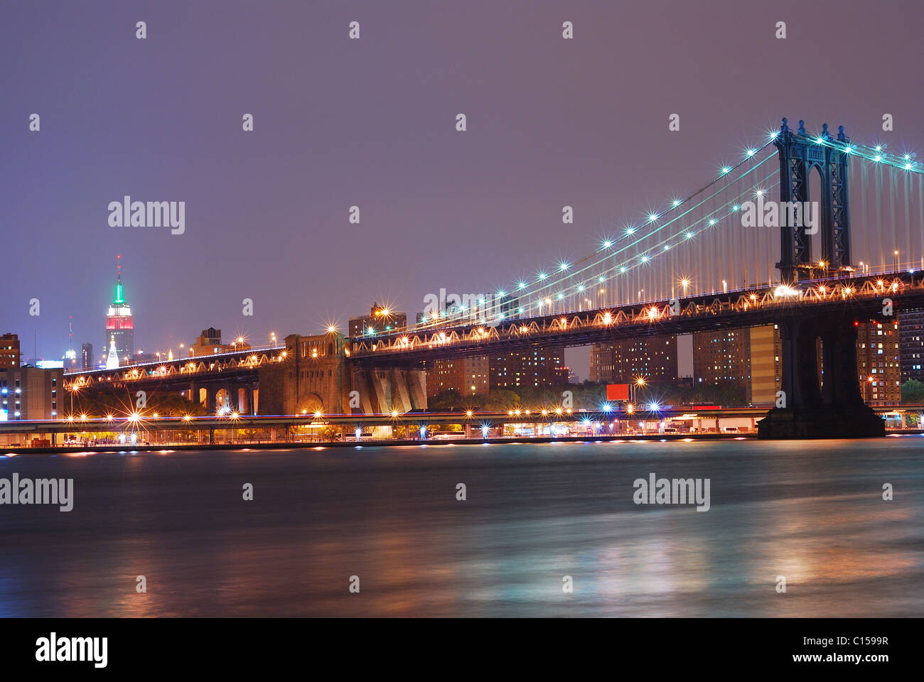 New York City night scene with Manhattan bridge and Empire State ...