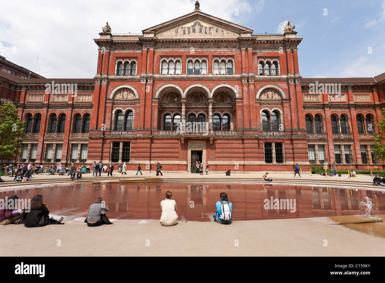 The reflecting pool and the old wing of the V&A. Tourists lounge around ...
