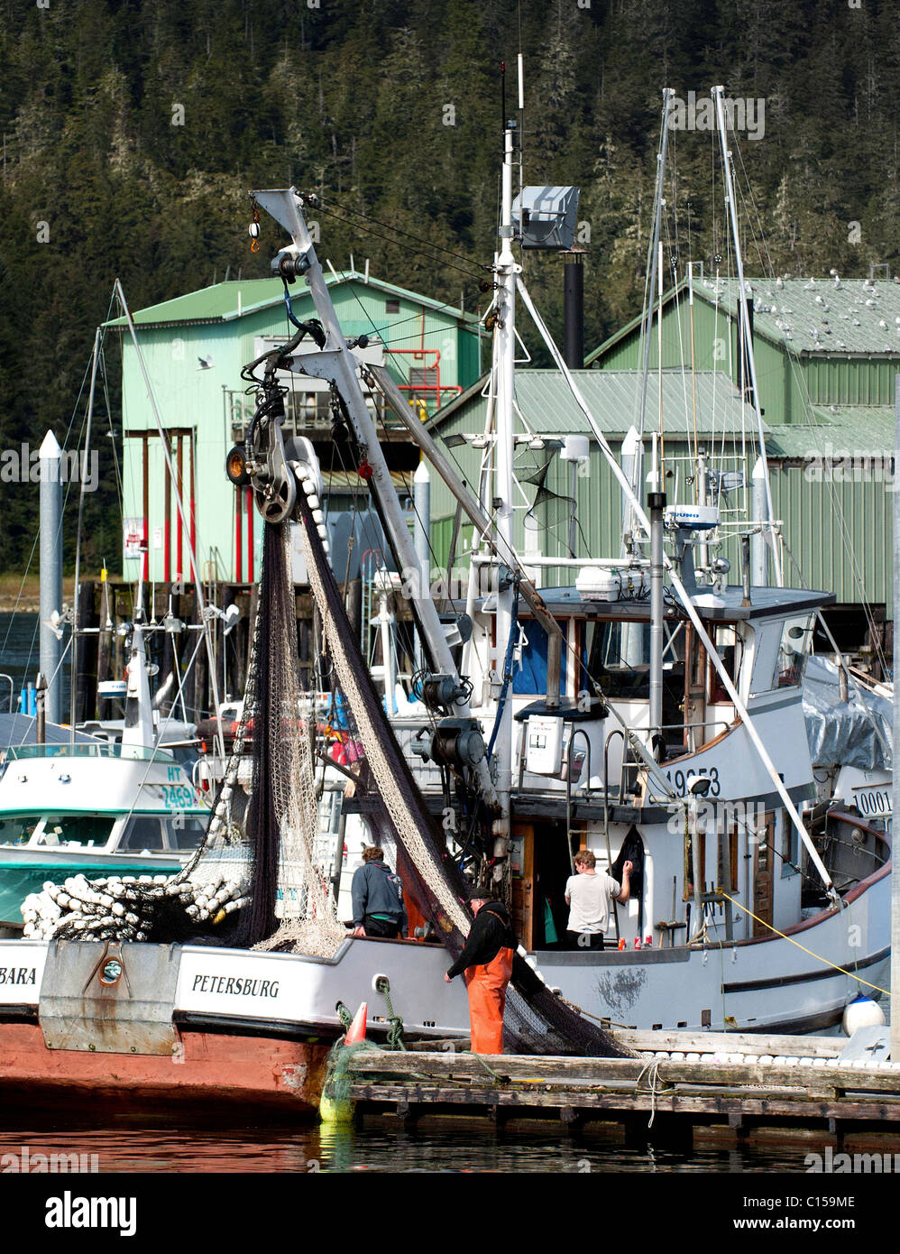 "Fishermen repair their net on the docks in Petersburg Alaska Stock ...