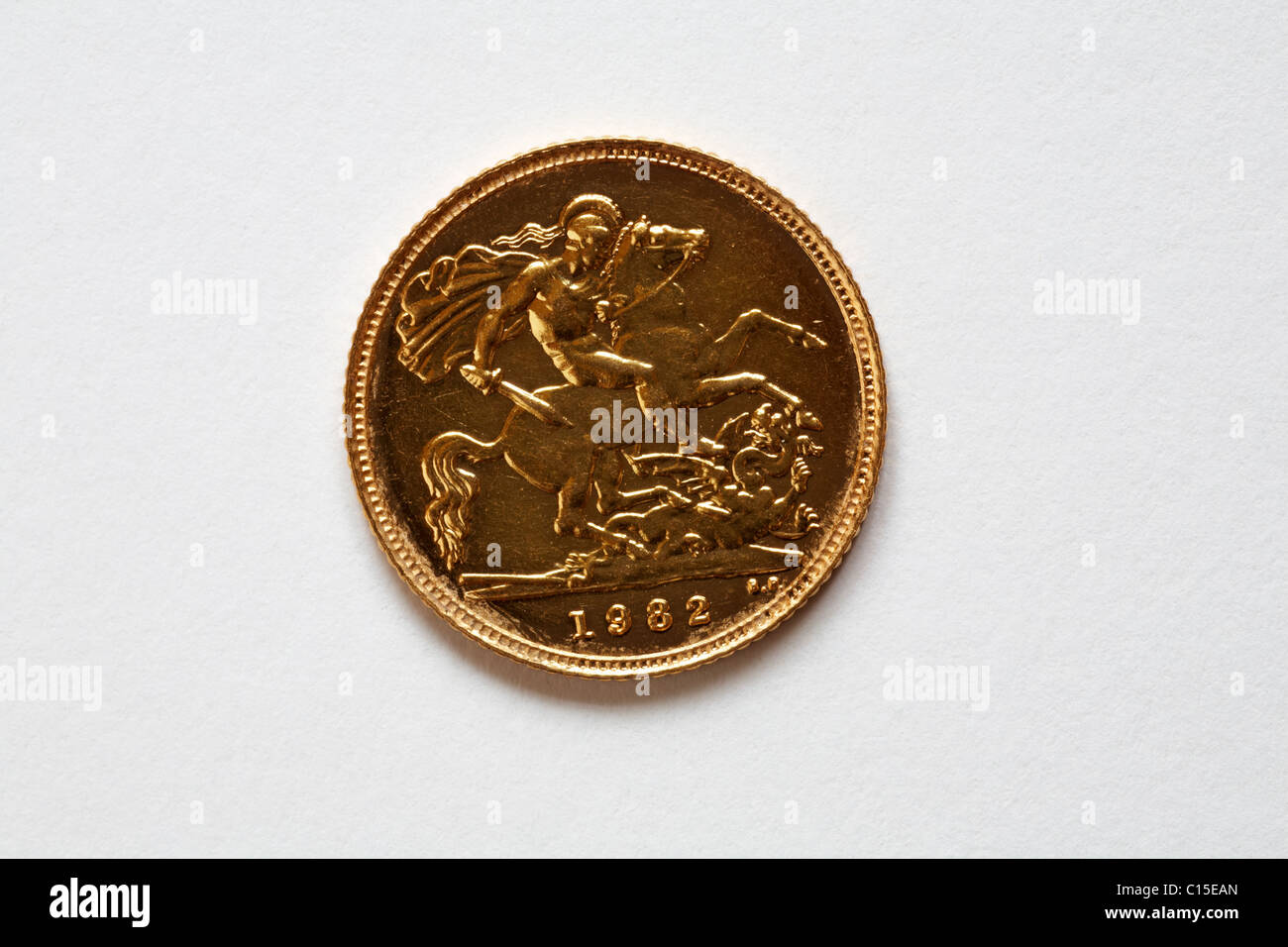 One gold half sovereign showing tail side isolated on white background ...