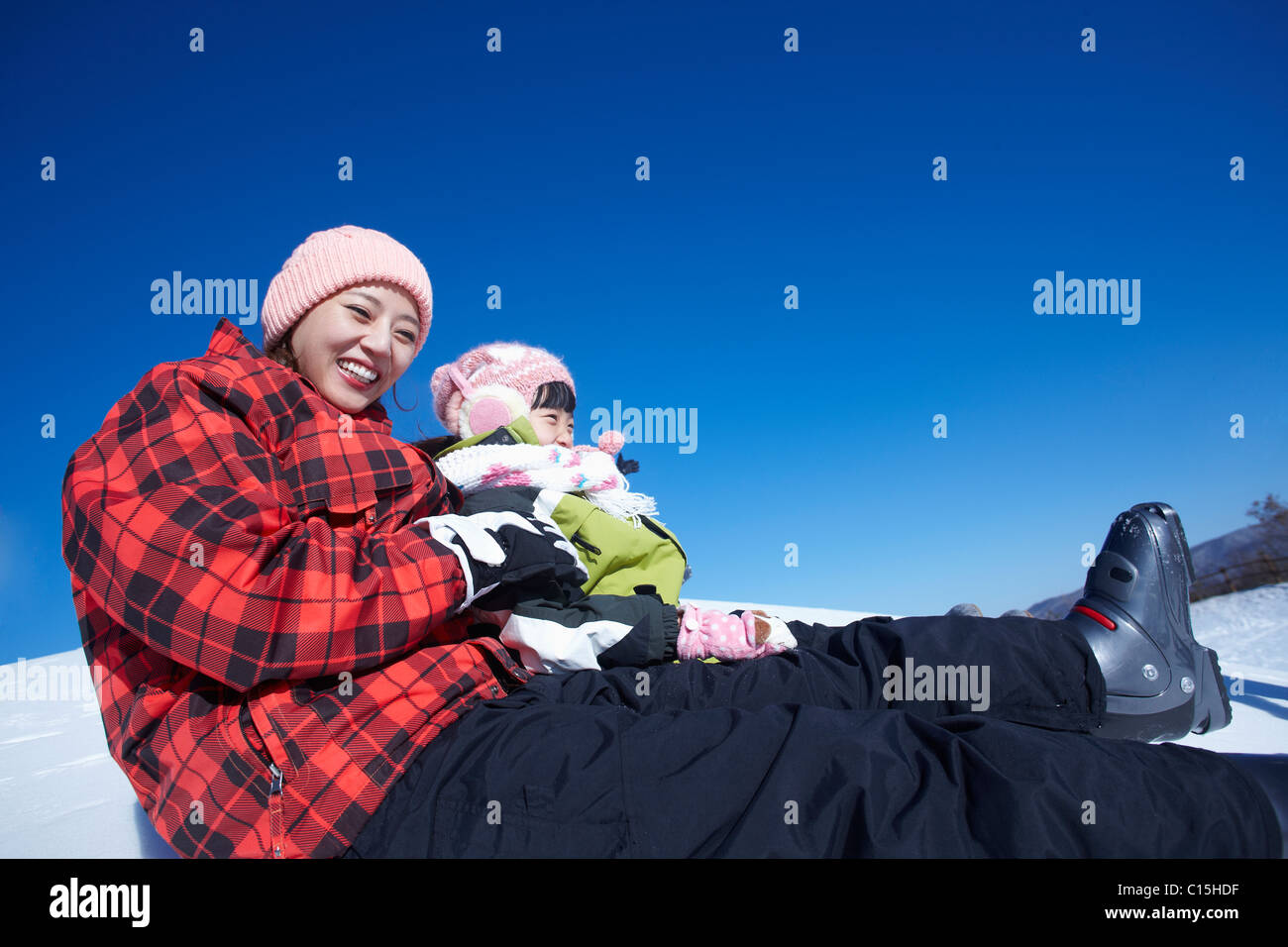 family having fun in ski resort Stock Photo - Alamy