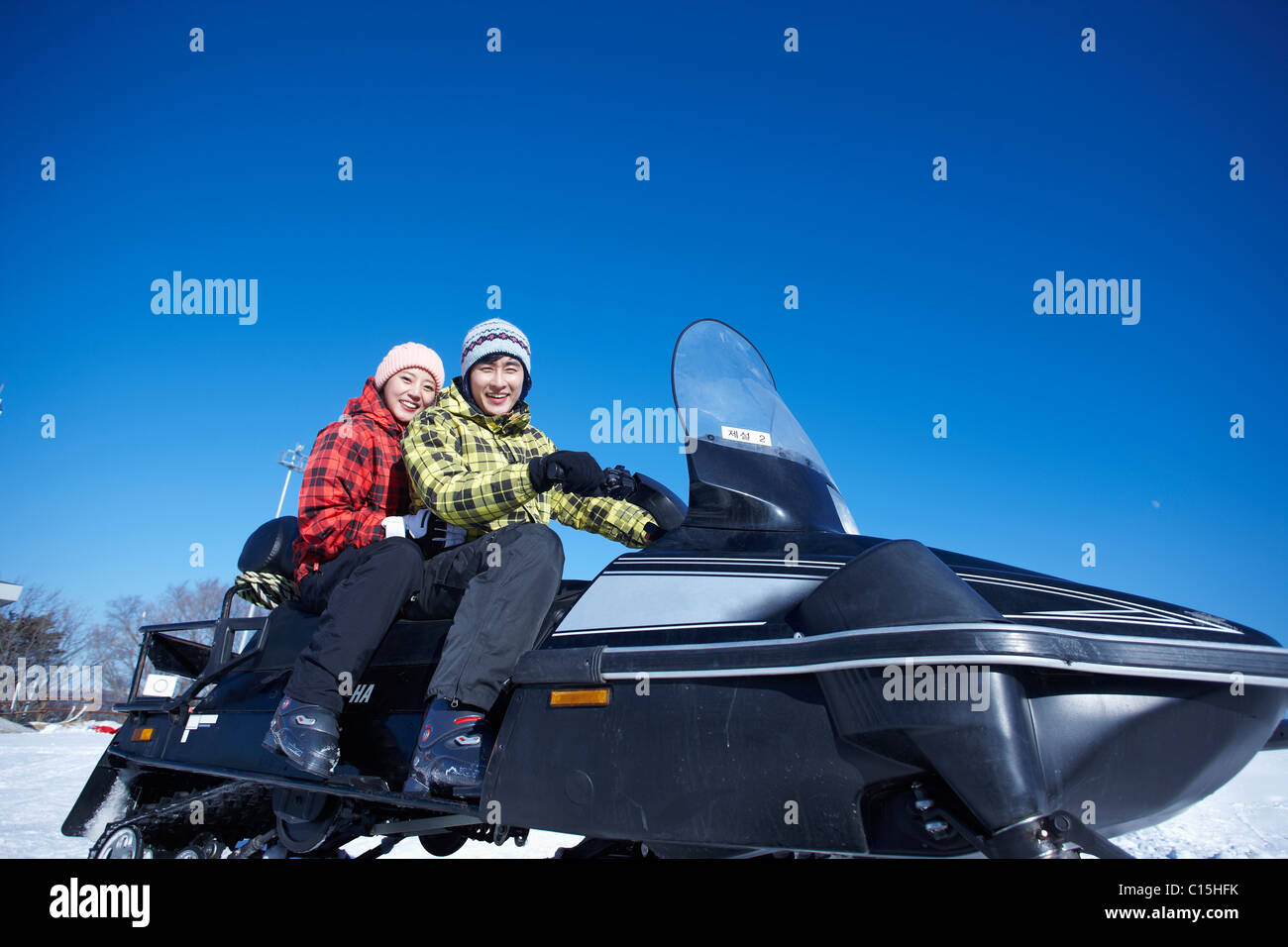 couple riding a motor ski vehicle Stock Photo - Alamy