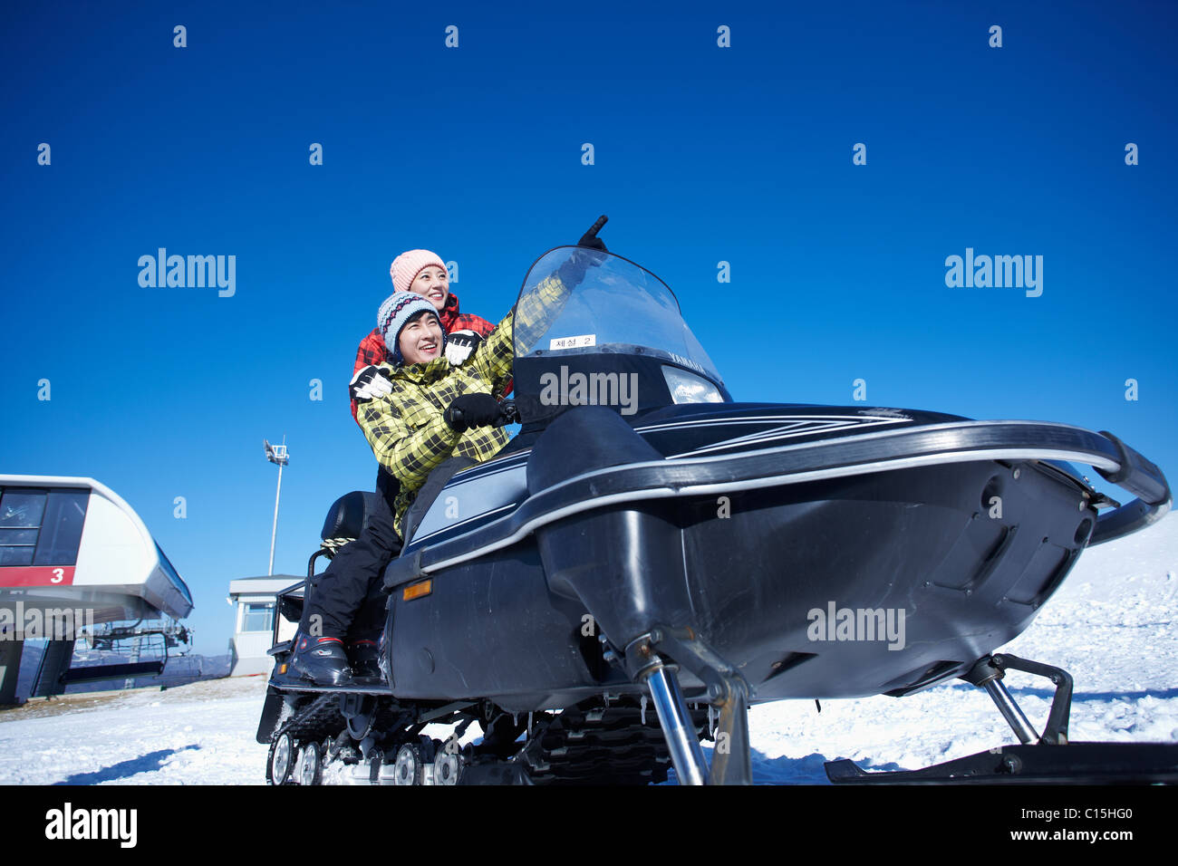 couple riding a motor ski vehicle Stock Photo - Alamy