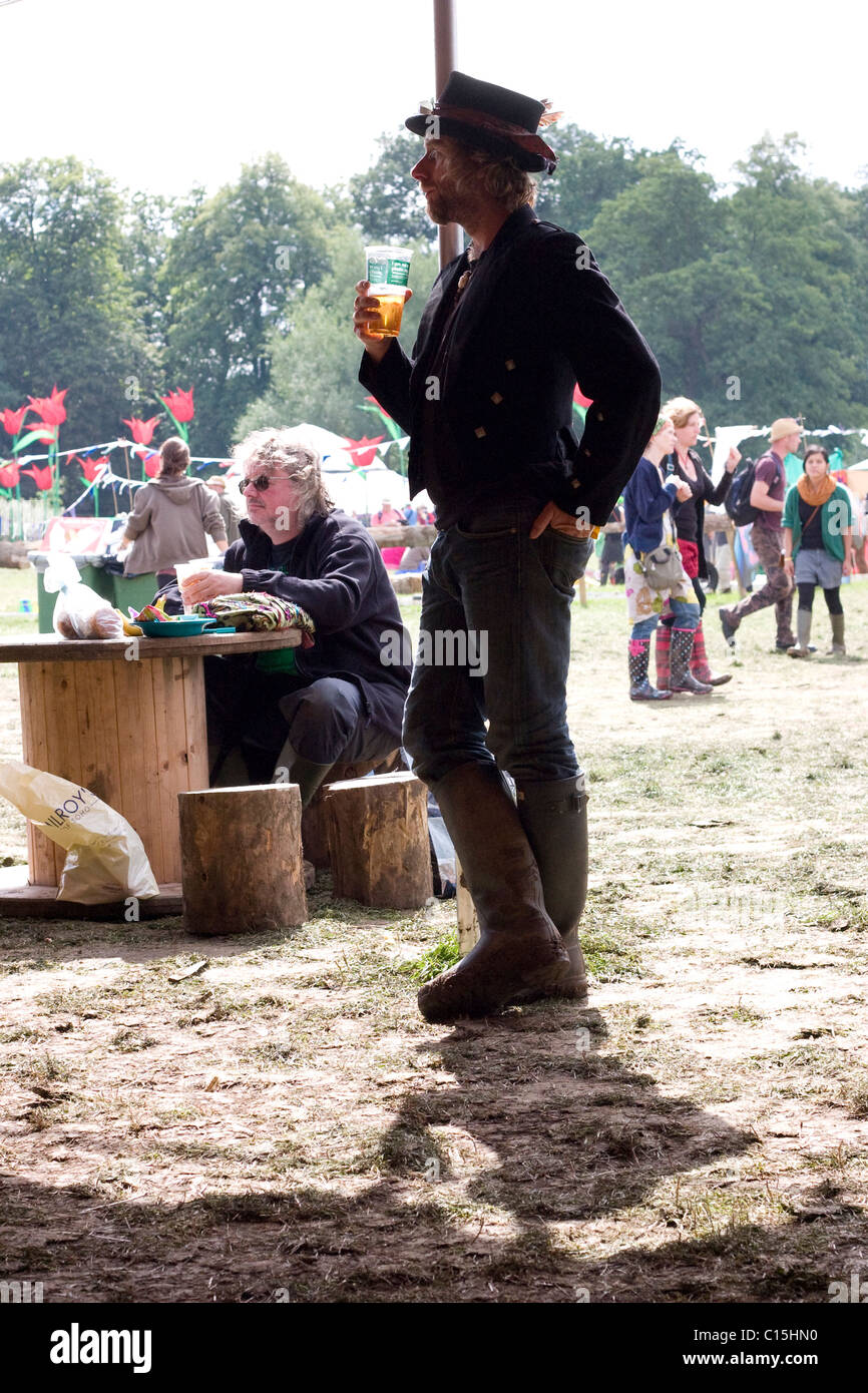 man drinking cider amidst festival goers Stock Photo - Alamy