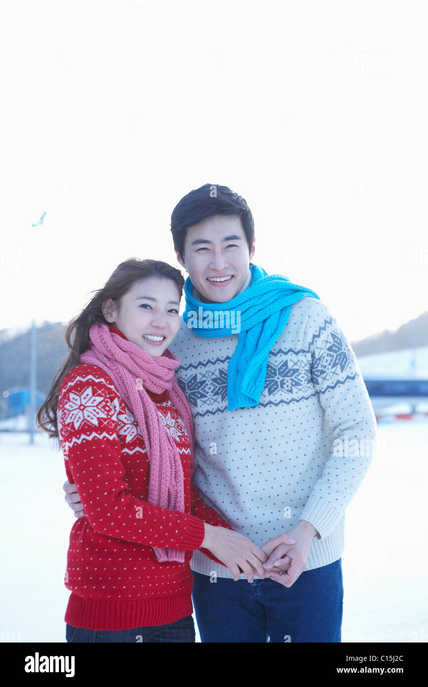 cordial couple holding hands in same clothing Stock Photo - Alamy