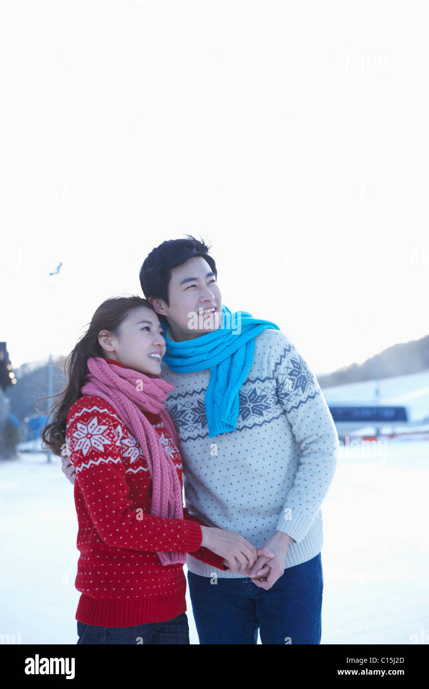 cordial couple holding hands in same clothing Stock Photo - Alamy