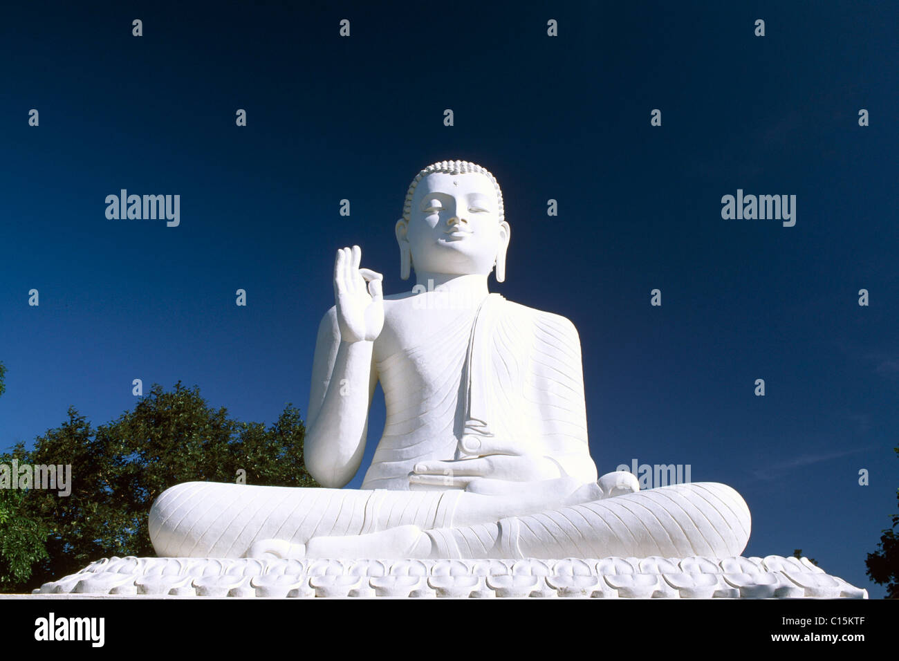 White buddha statue sits hi-res stock photography and images - Alamy
