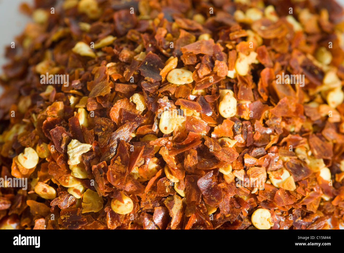 Crushed Chilli's on a white background Stock Photo - Alamy