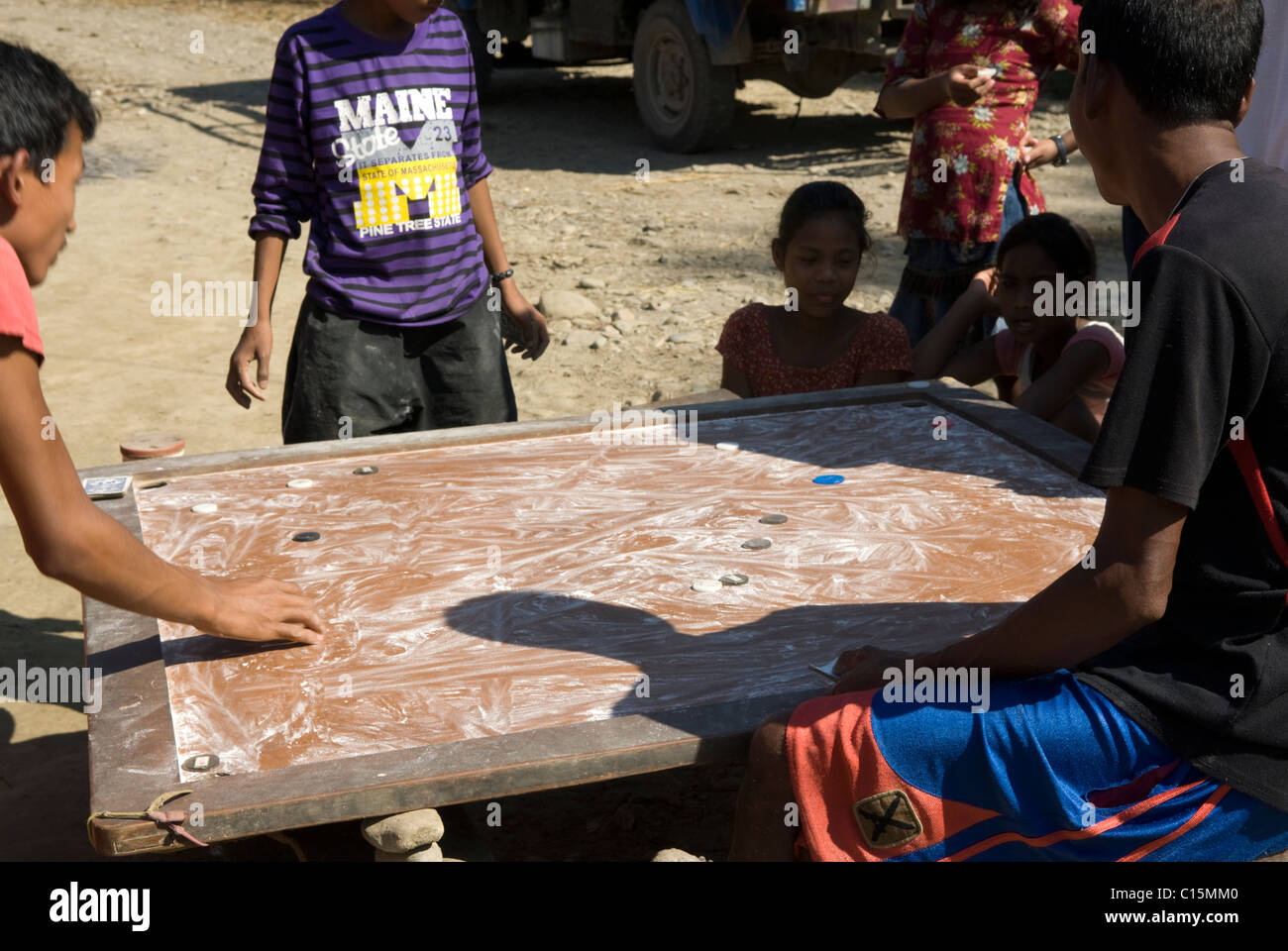 Children playing a traditional table / board game in a Tharu village ...