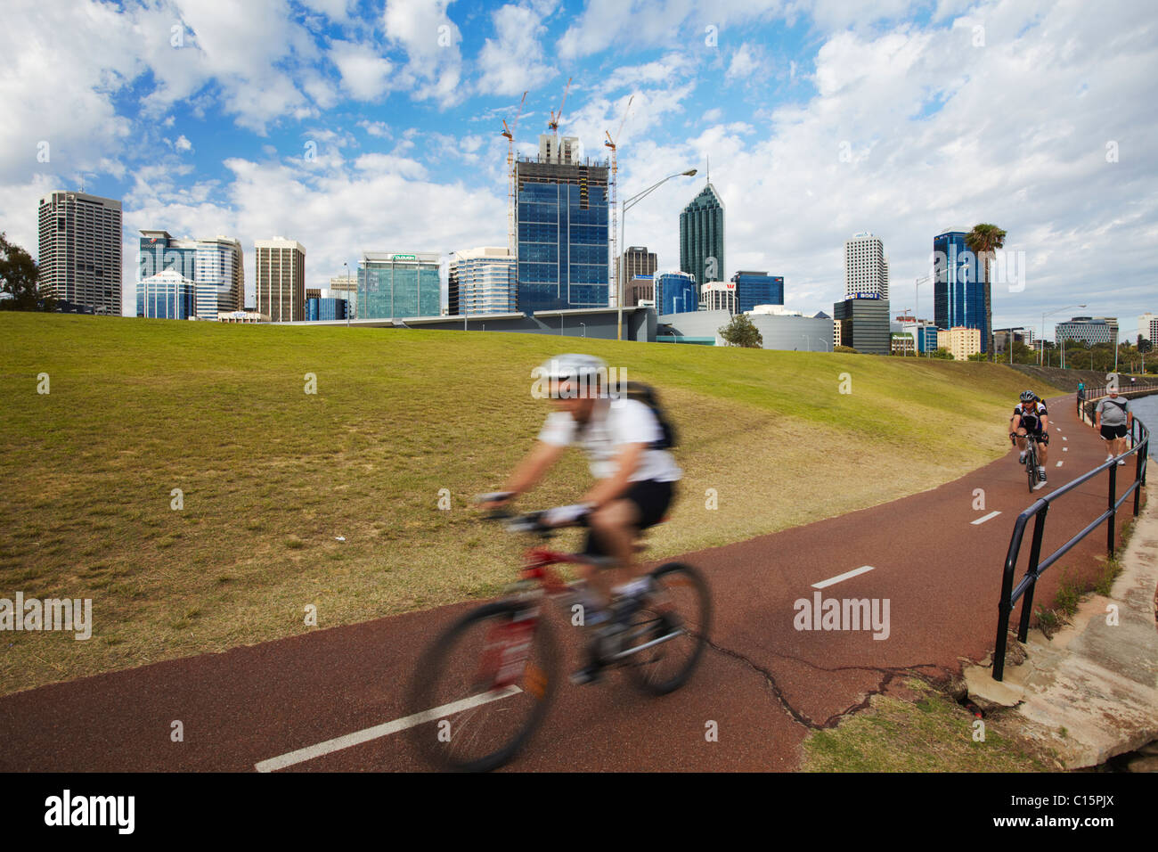 People cycling alongside Swan River, Perth, Western Australia ...