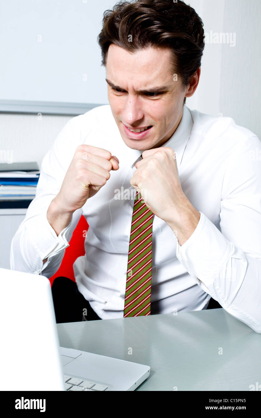 Businessman clenching his fist Stock Photo - Alamy