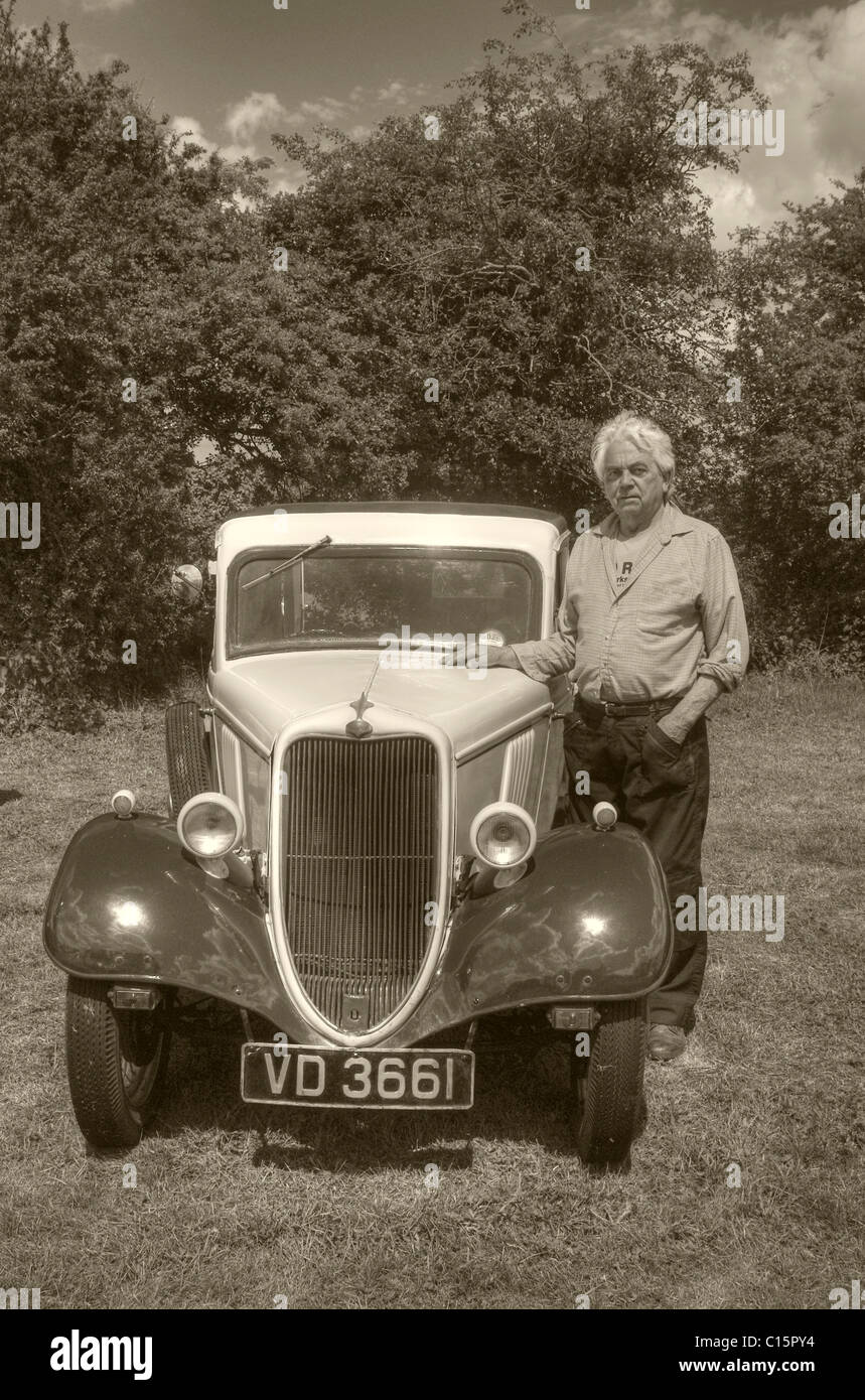 A proud owner poses by his Ford Ten van at a vintage vehicle show Stock ...