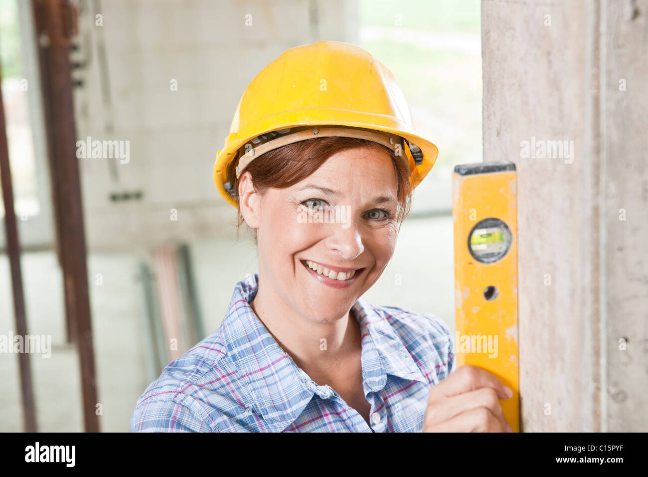 Woman level and helmet Stock Photo - Alamy