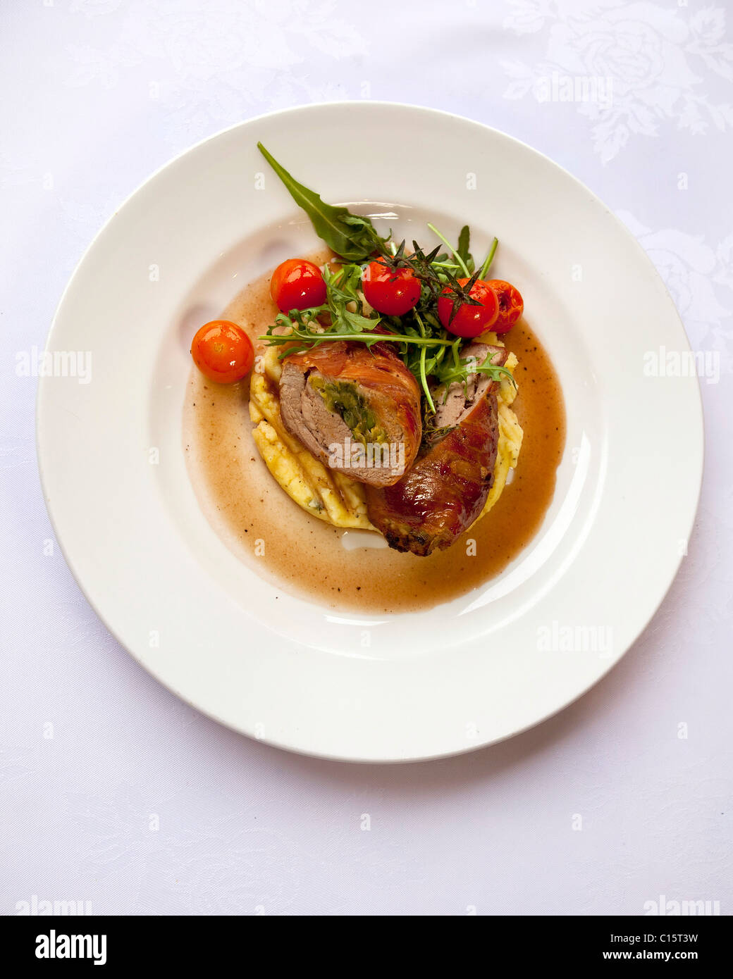 Main course stuffed pork fillet wrapped in "Parma ham" served on an ...