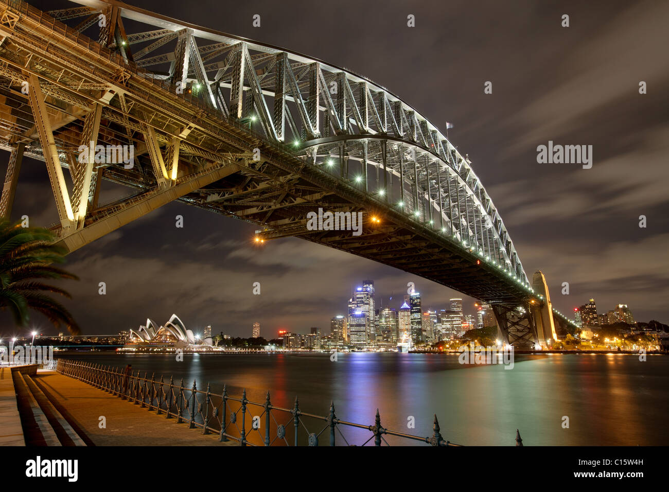 Sydney harbour bridge, skyline and Opera House with water reflection in ...