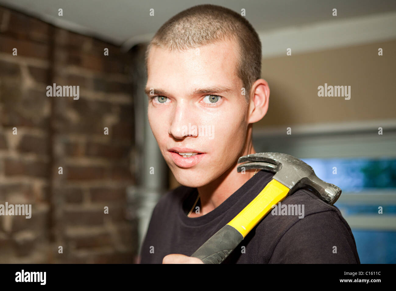 Young man with hammer, portrait Stock Photo - Alamy
