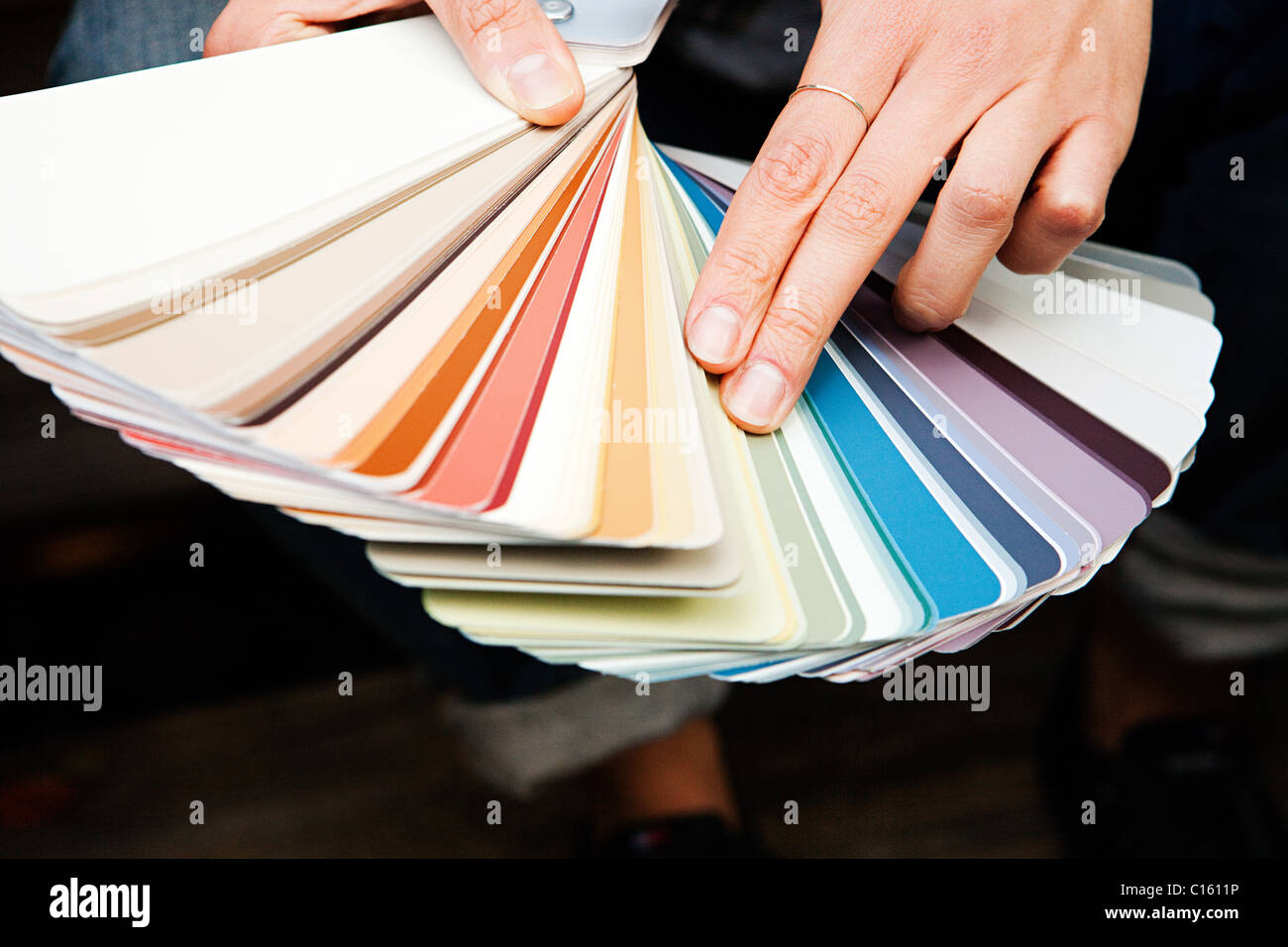 Woman looking at color swatch Stock Photo - Alamy