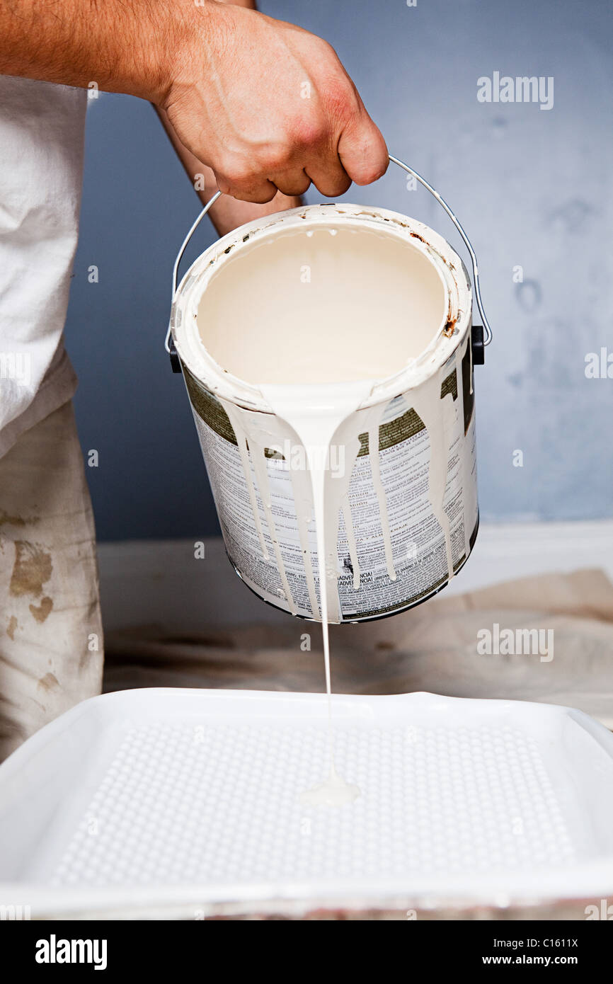 Man pouring paint Stock Photo - Alamy