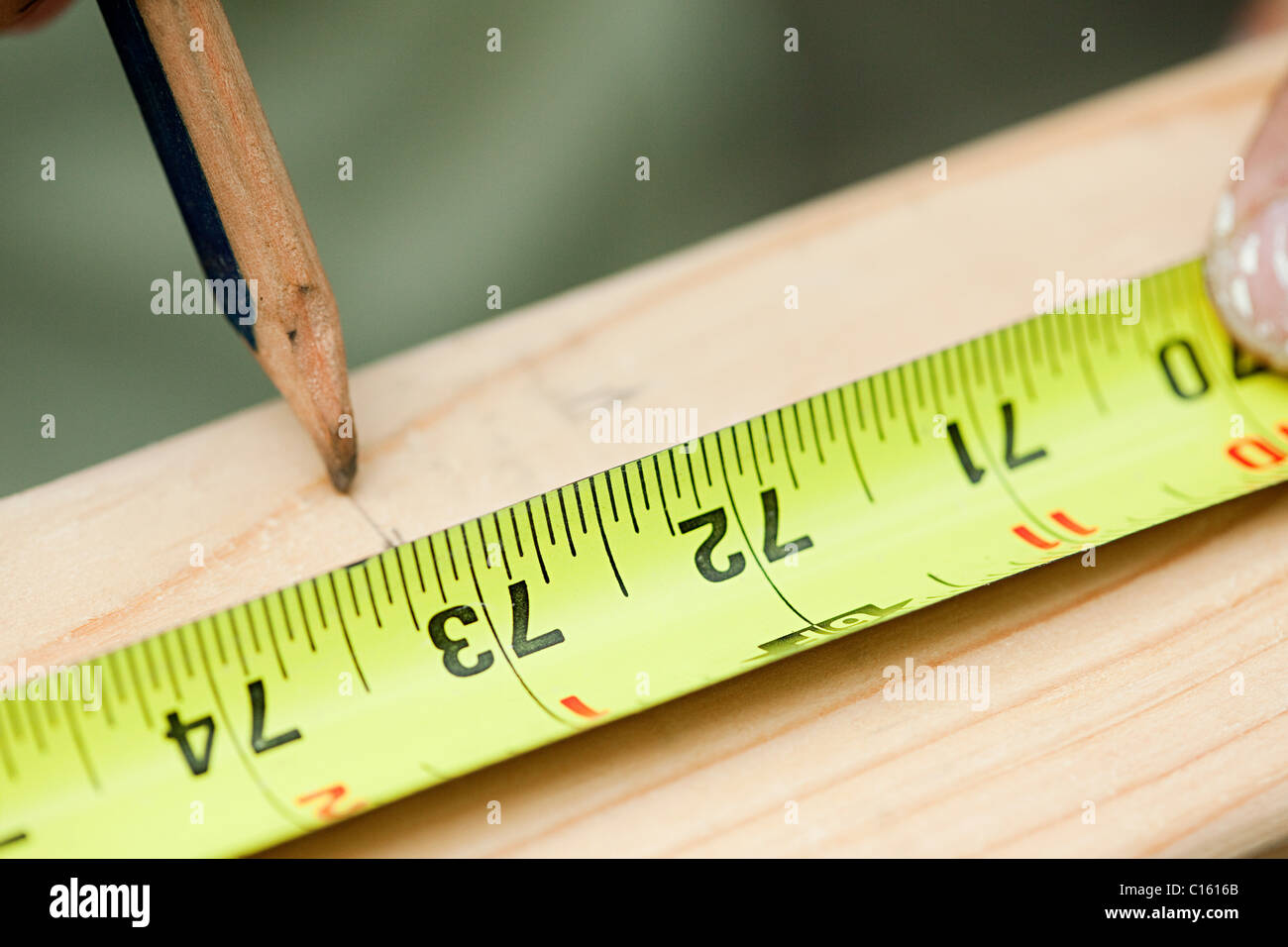 Measuring plank of wood and marking with pencil Stock Photo - Alamy