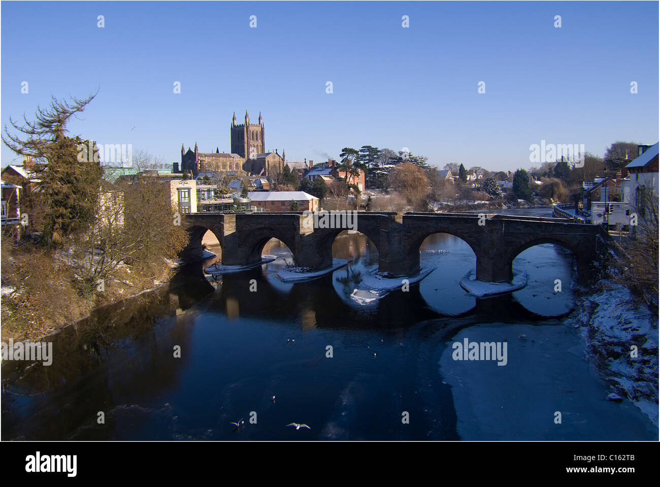Hereford cathedral stands proud above the old bridge and a frozen river ...