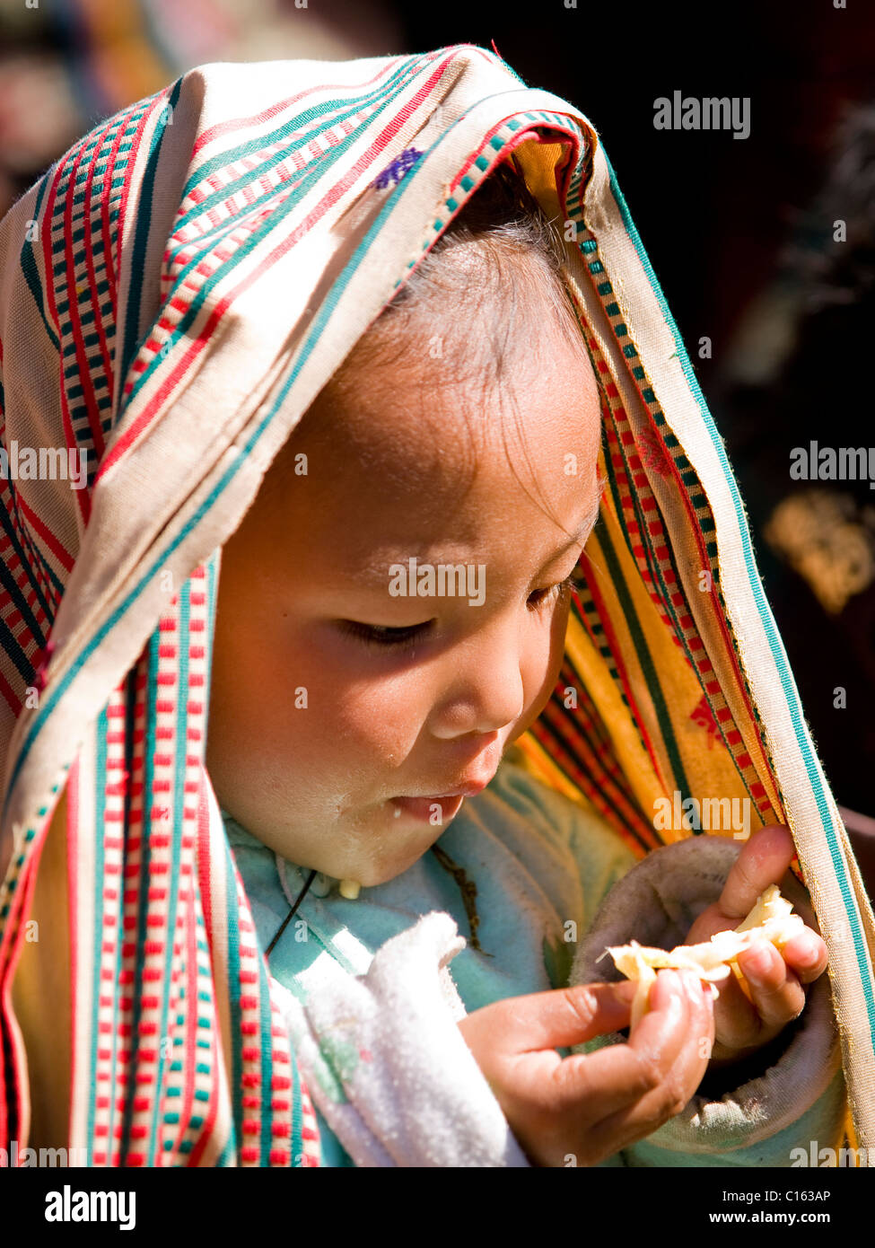 Young girl wearing a traditional Kira eating fruit Stock Photo - Alamy
