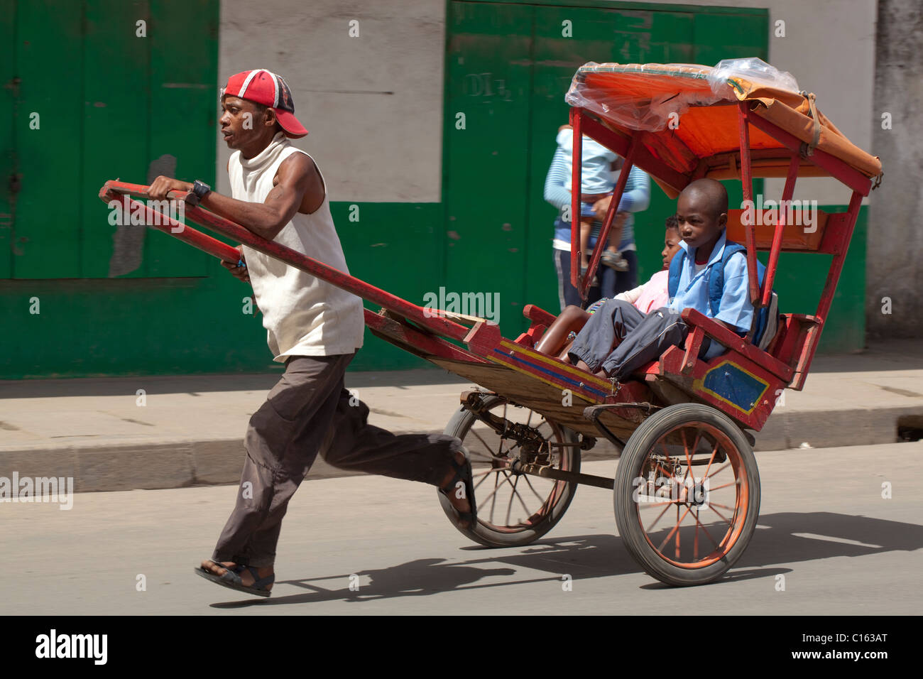 Girl and boy being taken to school in a Push-push, Pousse pousse ...