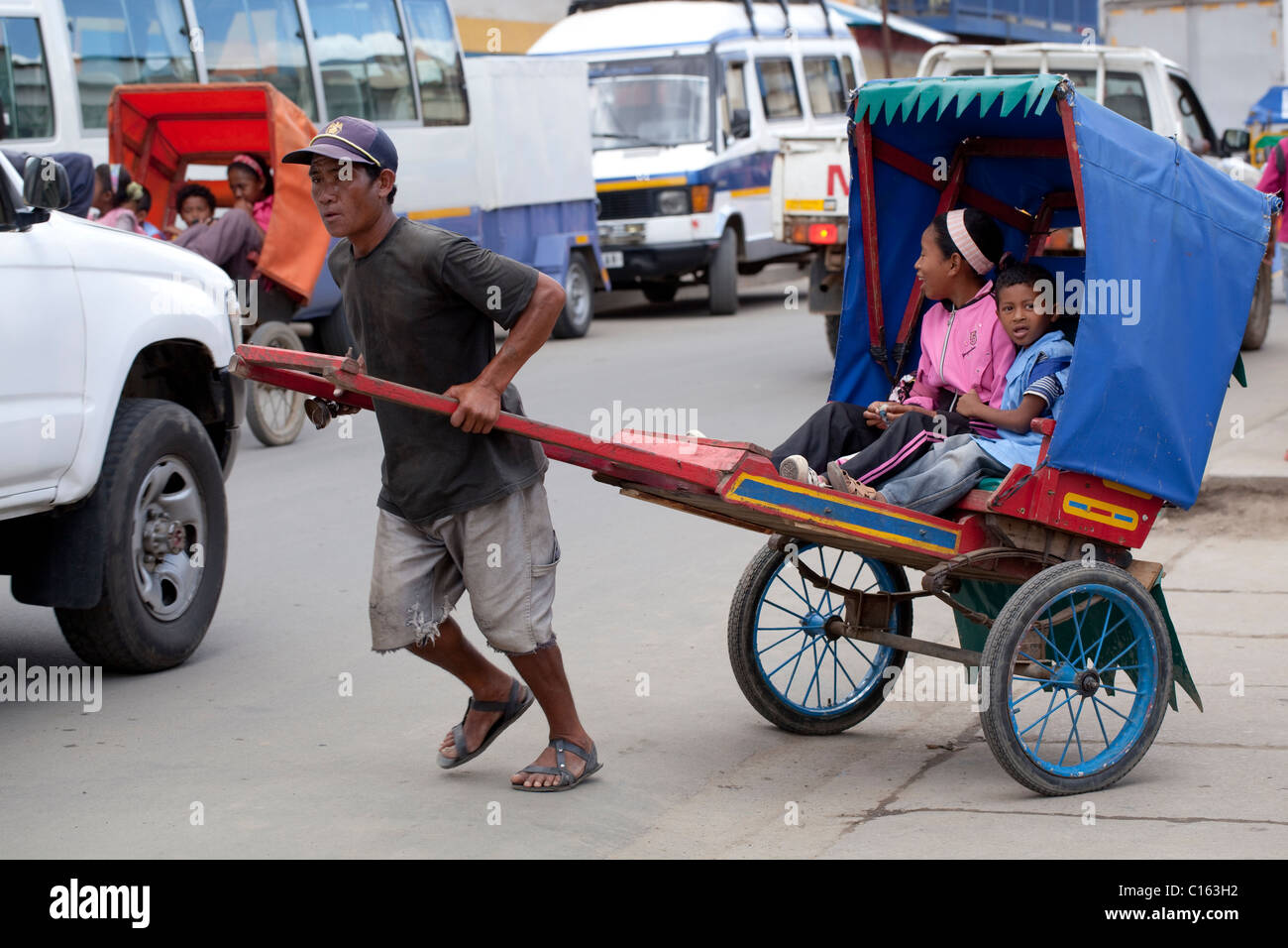 Girl and boy being taken to school in a Push-push, Pousse pousse ...