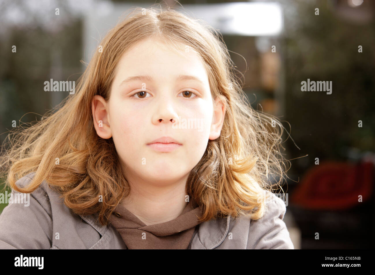 Boy 10 Years Old With Long Hair Looking Into The Camera Stock Photo