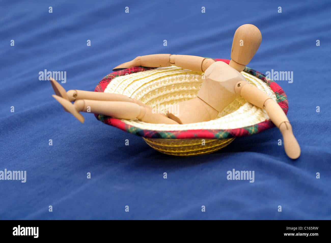 A mannequin resting in a hat, as if floating on a river Stock Photo - Alamy