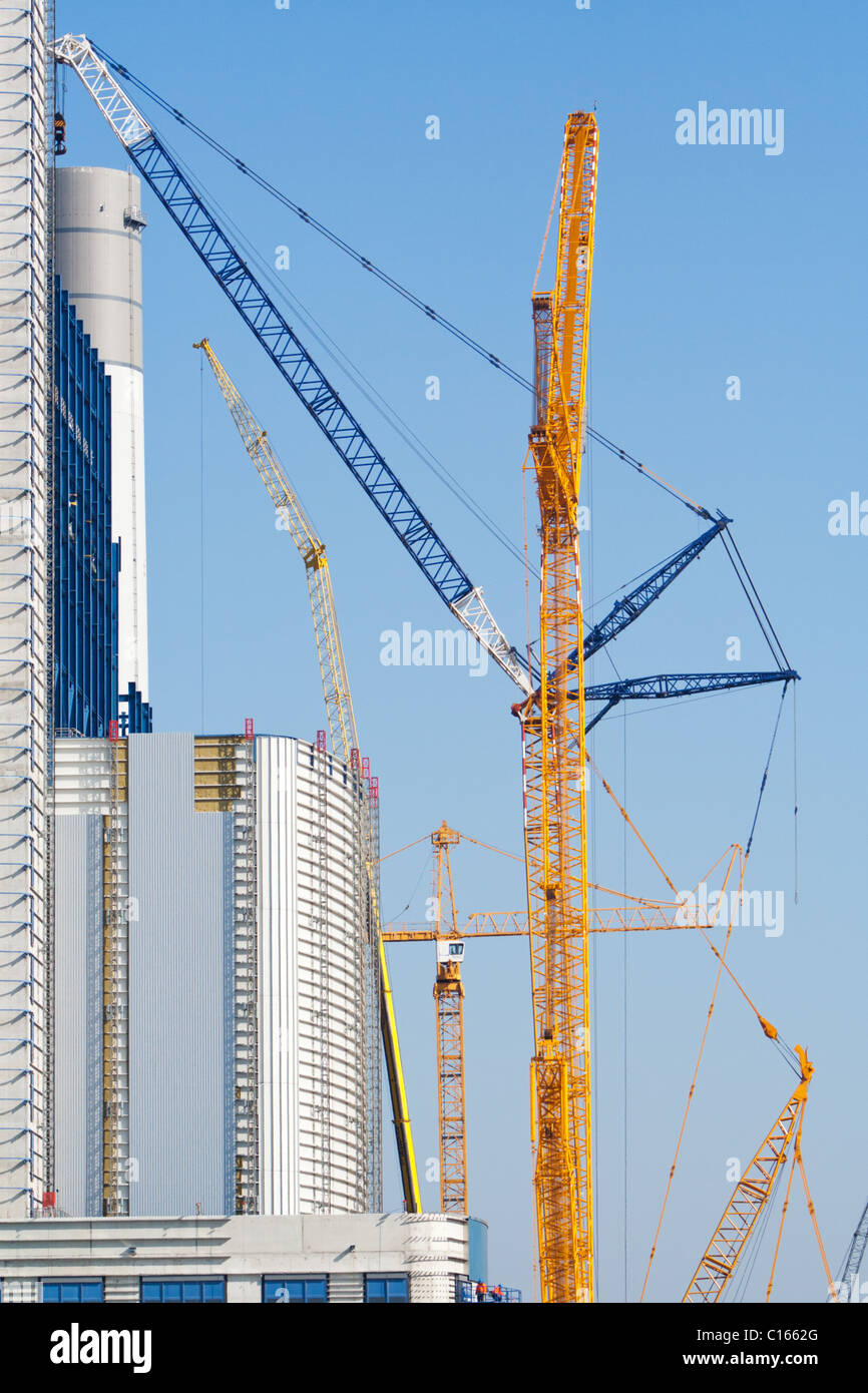Various cranes at a large construction building site Stock Photo - Alamy