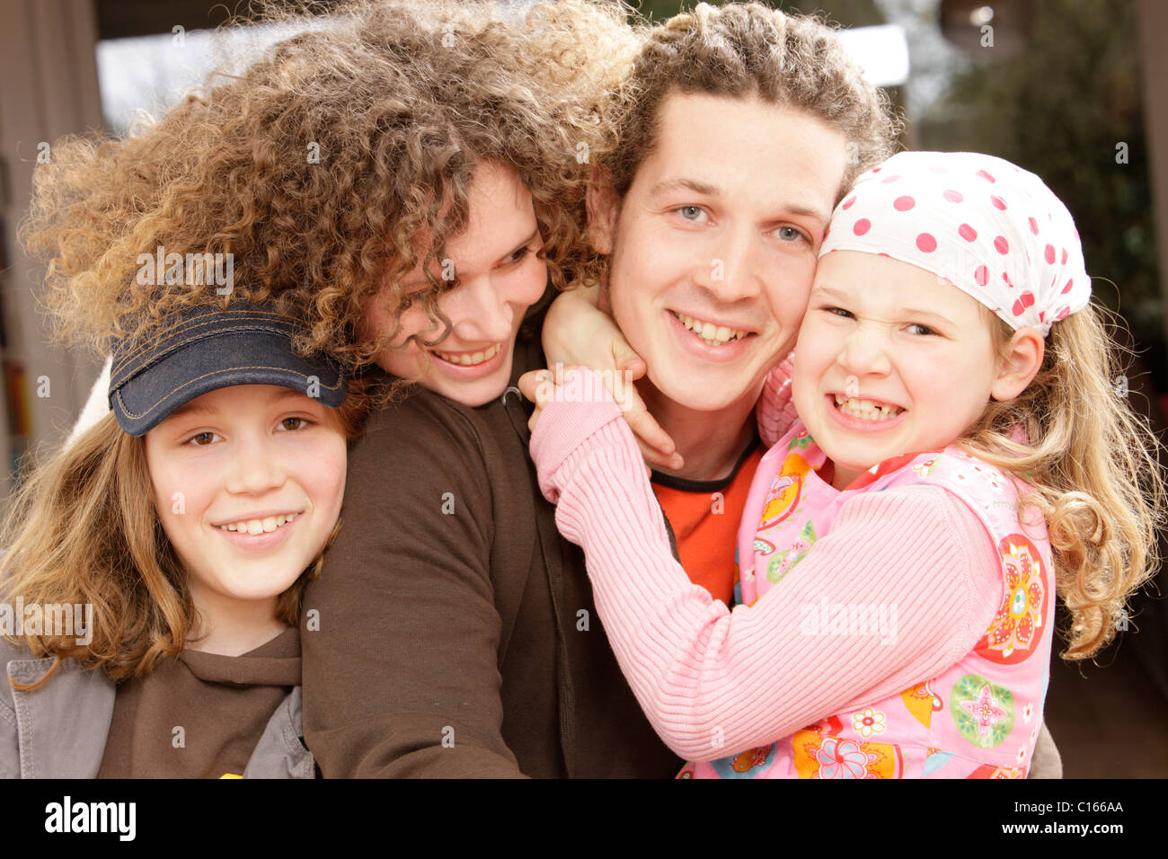 Family, all have long hair, smiling Stock Photo - Alamy