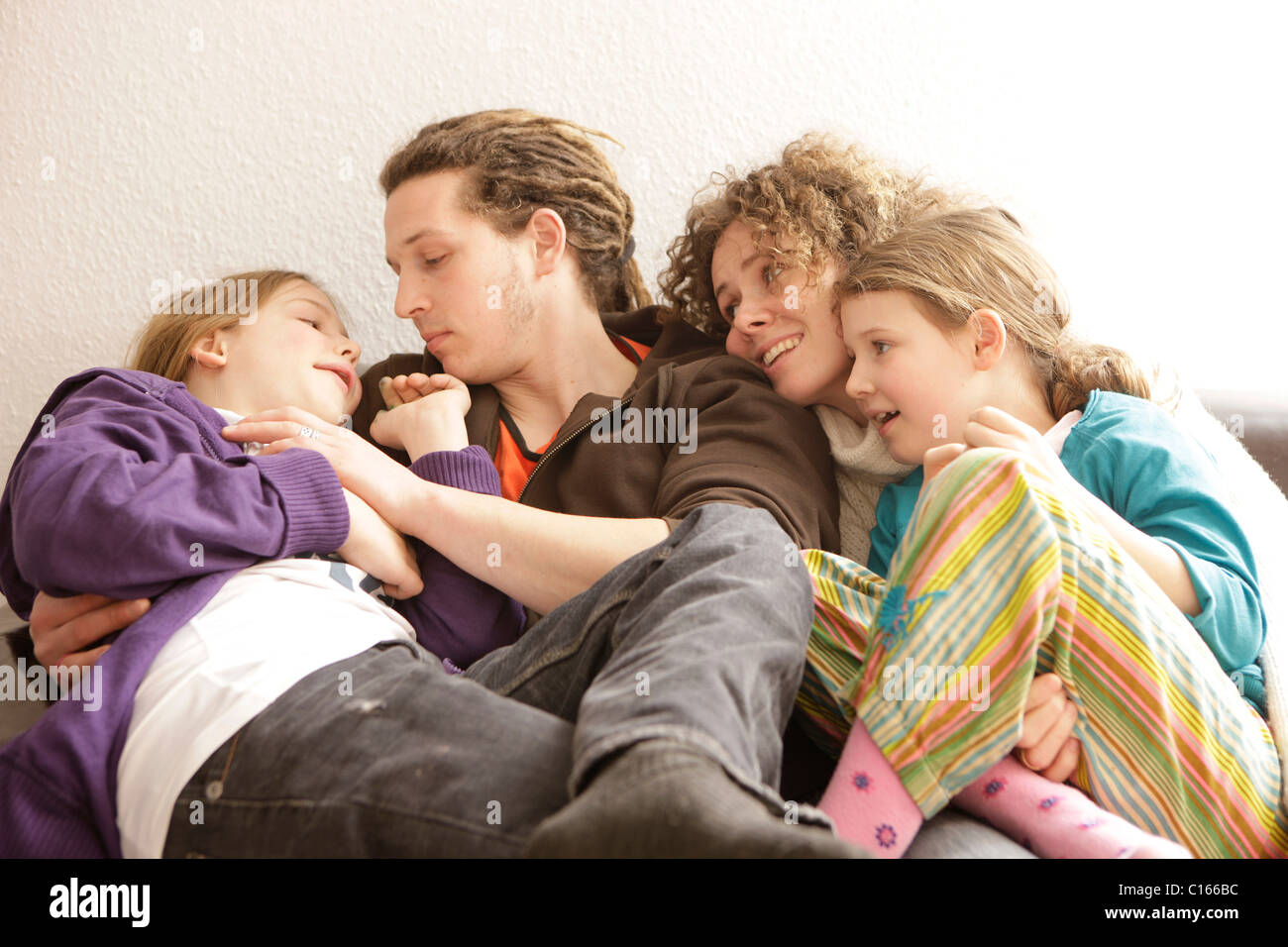 Family, all have long hair, smiling Stock Photo - Alamy