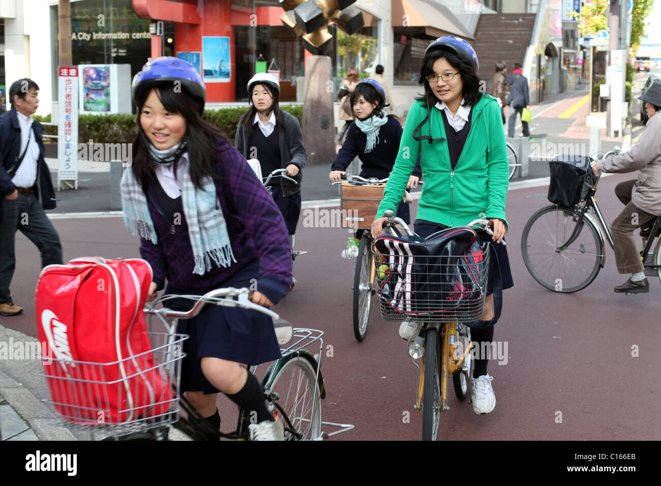 Japanese schoolgirls cycling home from school, Nara, Honshu, Japan ...