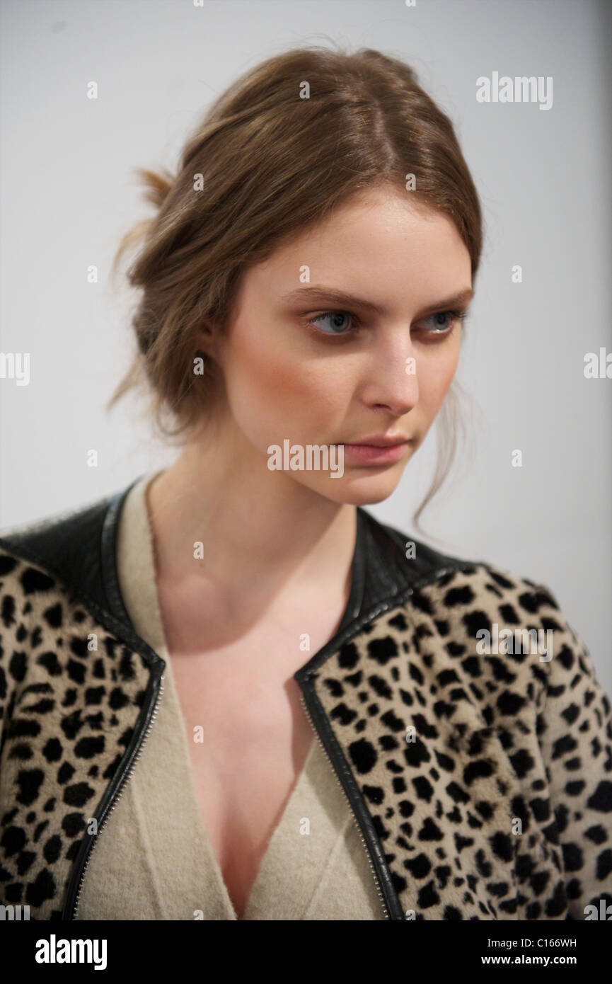 A model poses for a photograph backstage before the Matthew Williamson ...