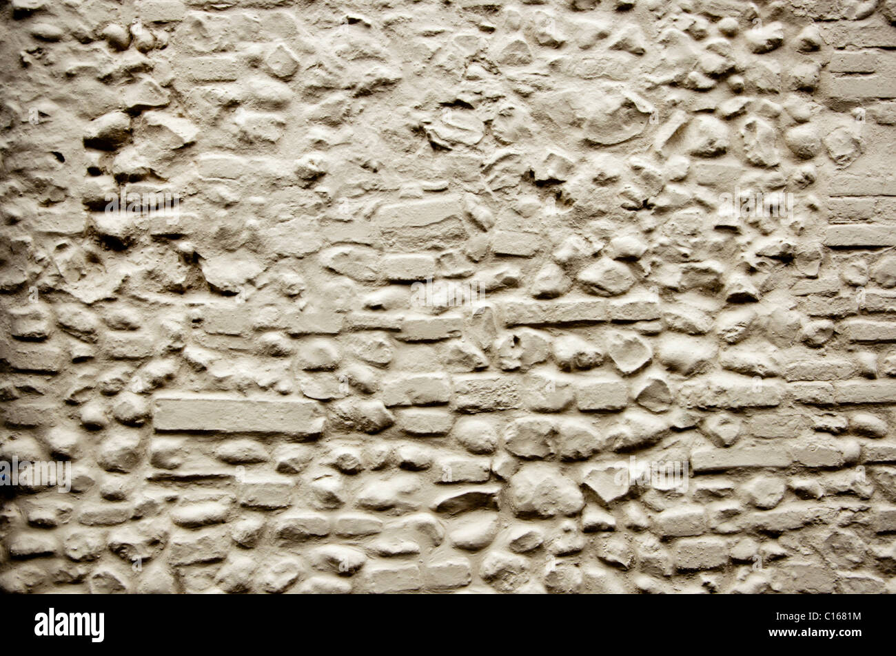 Detail of wall and Brick work with flint painted white Stock Photo - Alamy