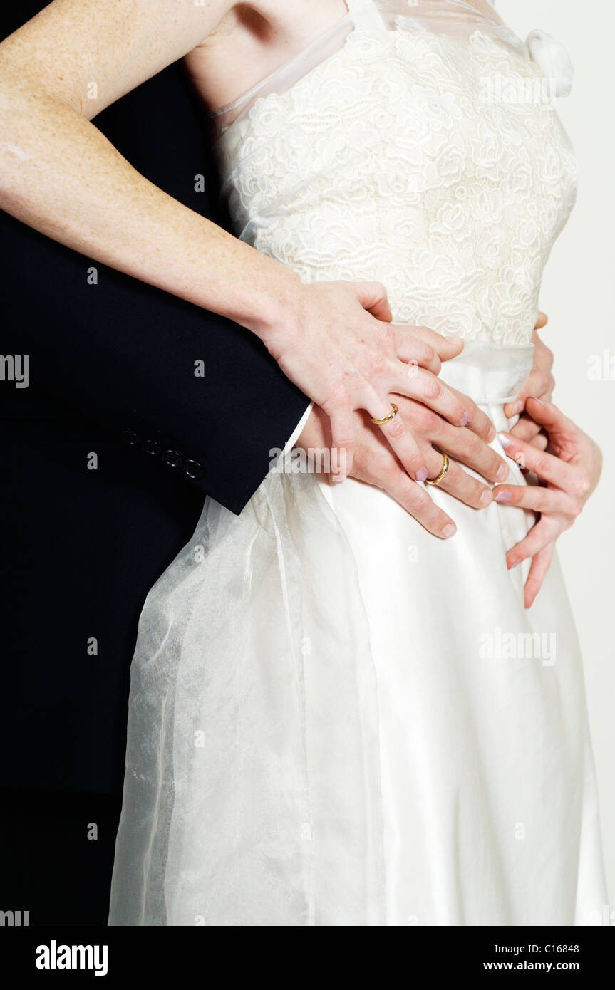 Bridegroom embracing his bride from behind Stock Photo - Alamy