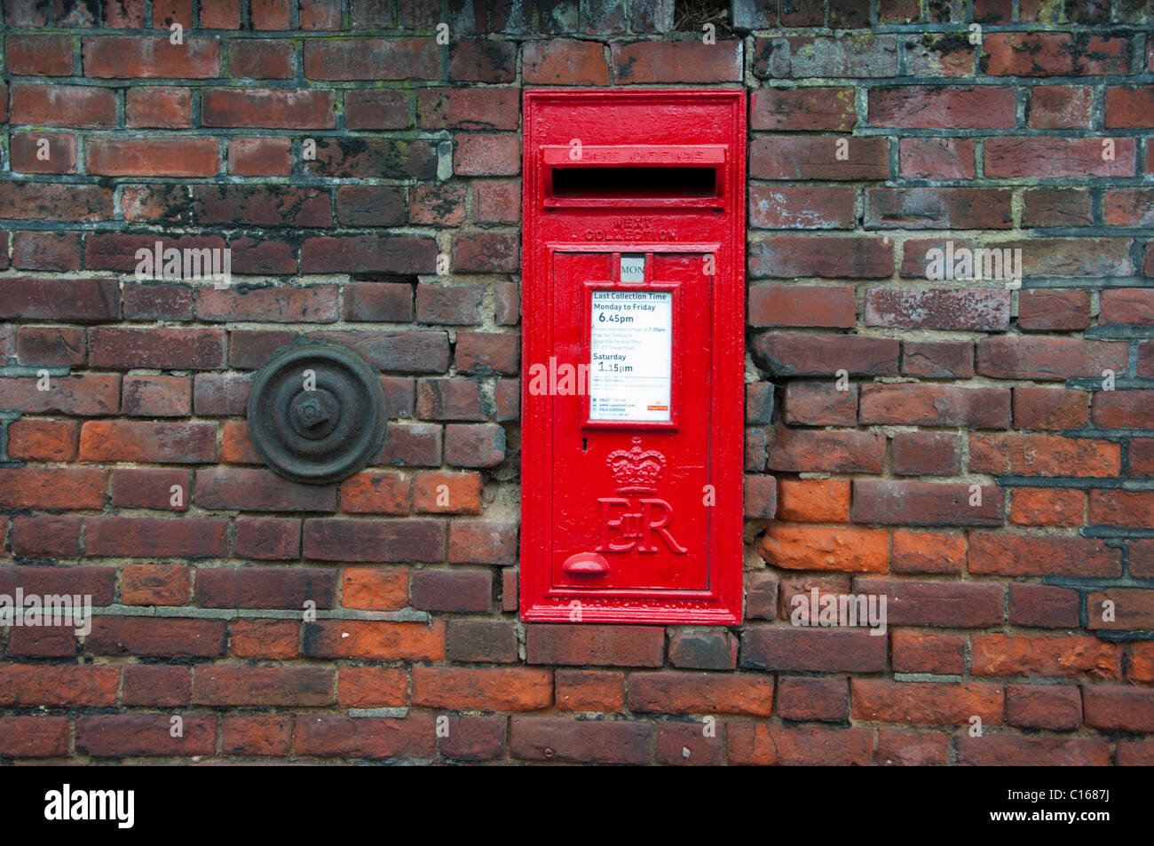 Red post box built into a brick wall Stock Photo - Alamy