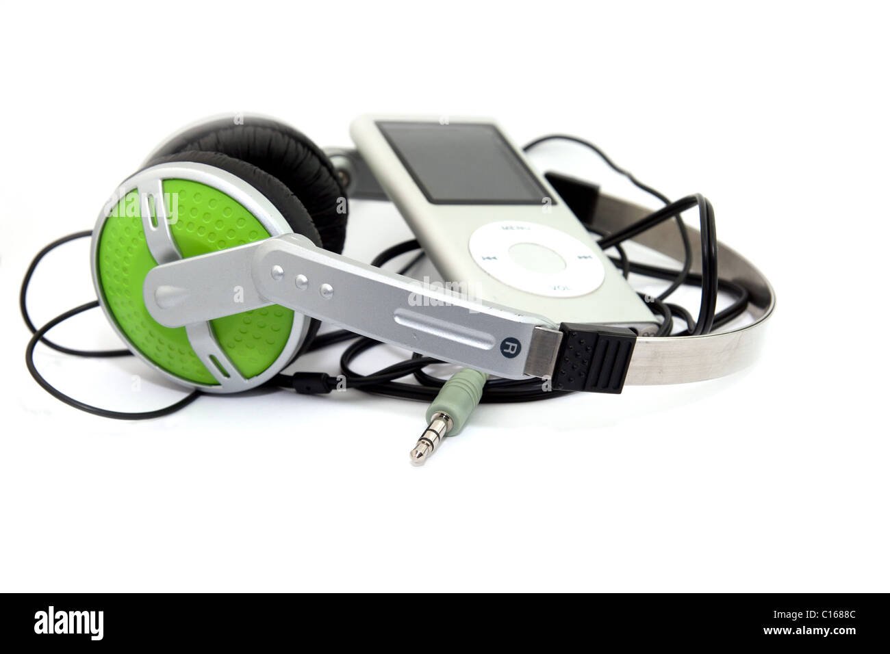green headphones and mp3 player on white background Stock Photo - Alamy