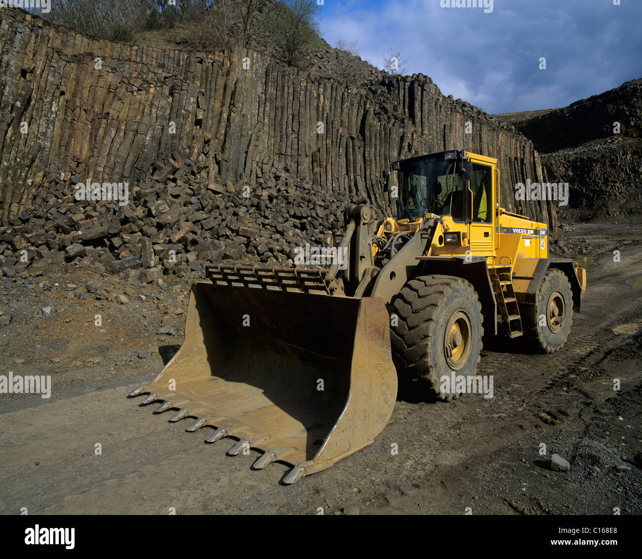 Basalt stone, yellow excavator in basalt stone quarry Stock Photo - Alamy