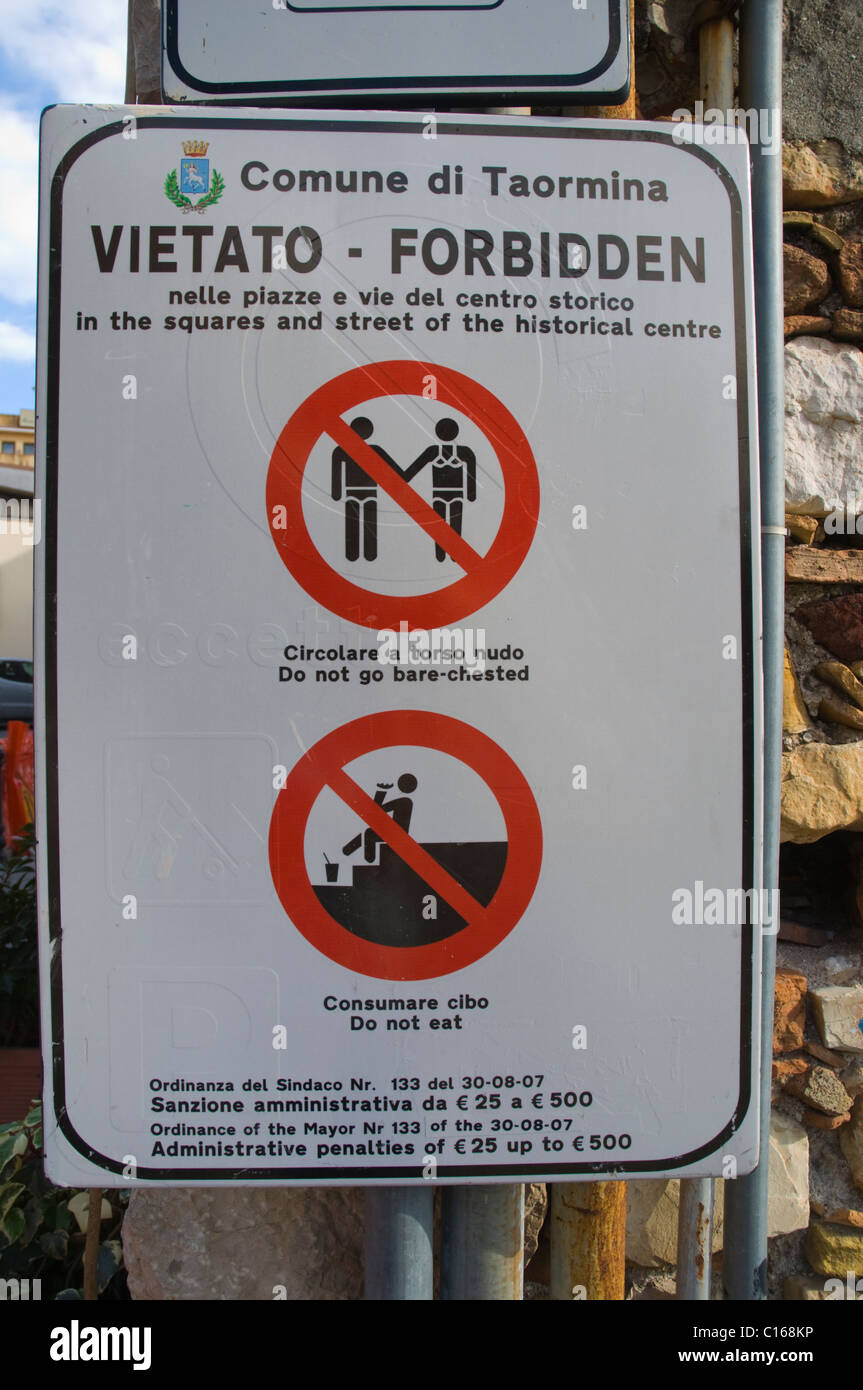 Warning sign about dressing and eating old town Taormina Sicily Italy ...