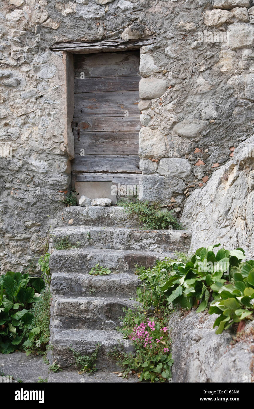 Ancient stone house with steps and a wooden door. Entrevaux, France ...