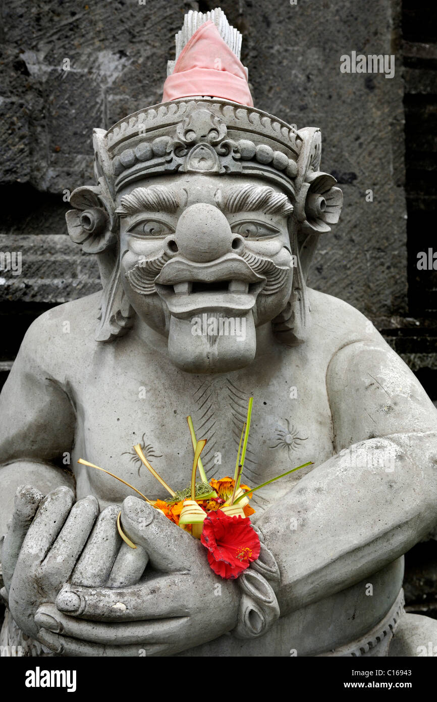 Figure from Balinese mythology near Rendang with an offering, Bali ...