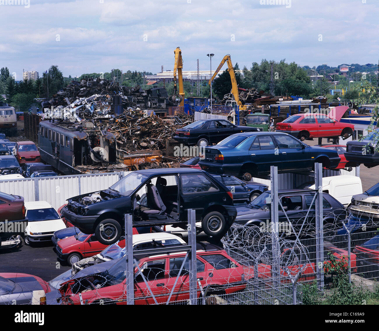 Wrecking yard, scrapyard, cars and electric locomotives, recycling ...