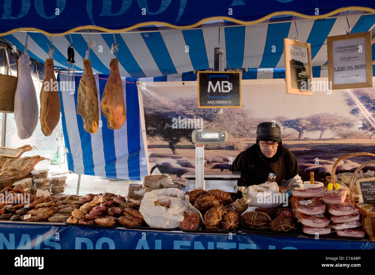 Man selling meats at Saturday morning market in Estremoz, Portugal ...