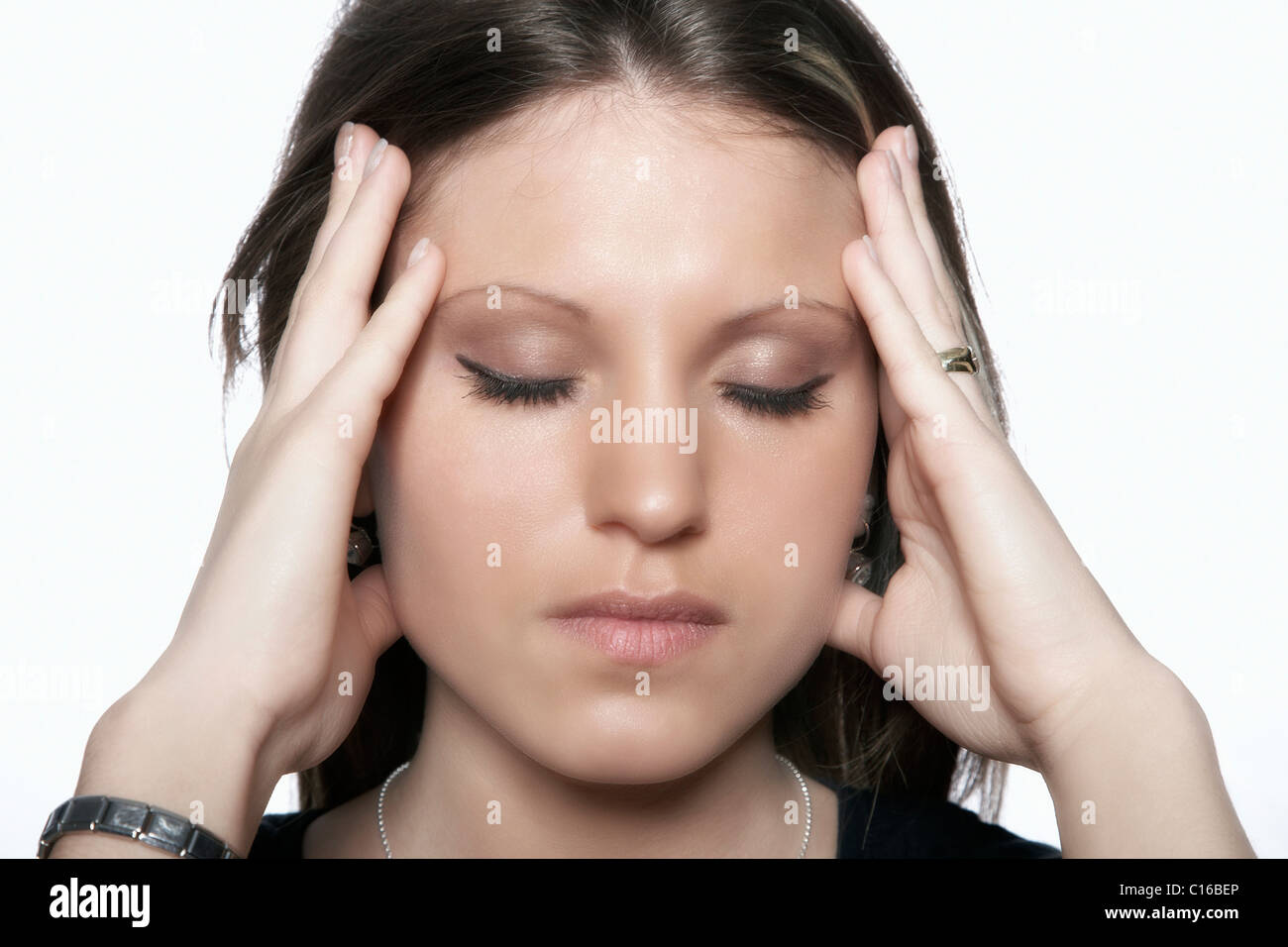 Young woman holding temples hi-res stock photography and images - Alamy