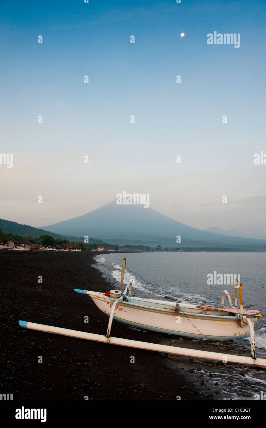 Before sunrise a traditional Balinese fishing boat, called a jukung ...