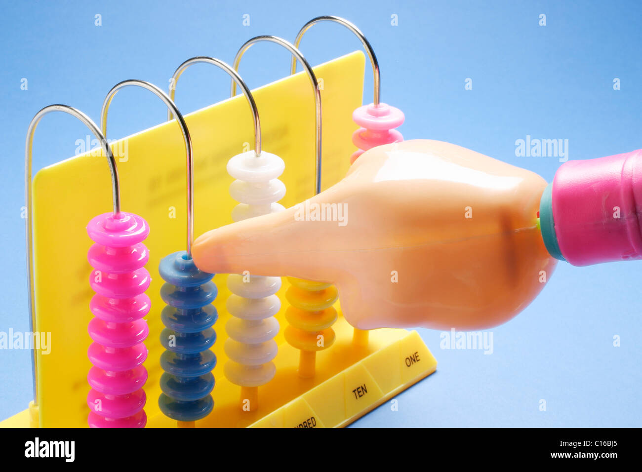 Plastic hand with children's abacus Stock Photo - Alamy