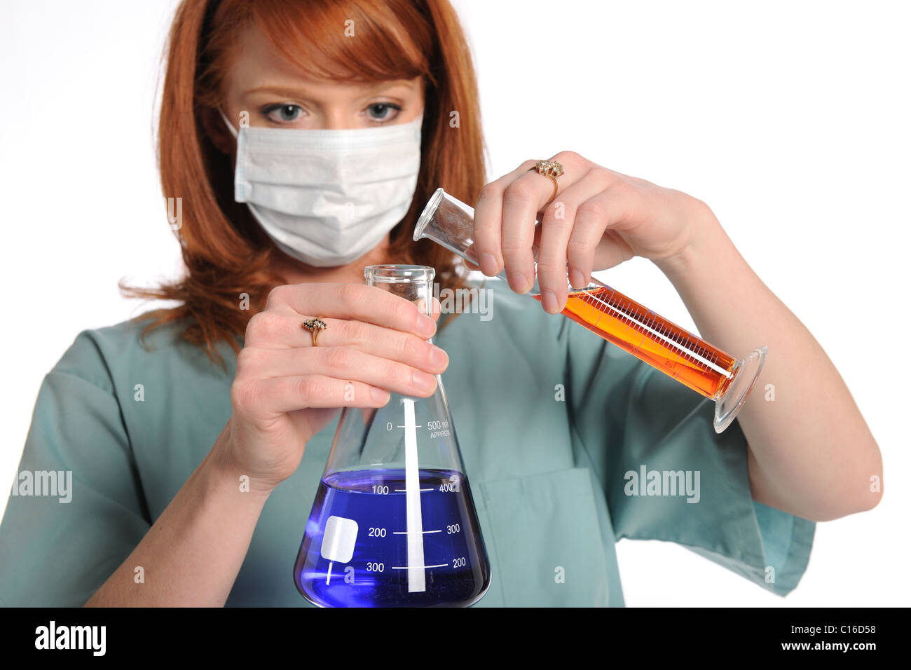 Female laboratory tech mixing chemicals isolated over white background ...